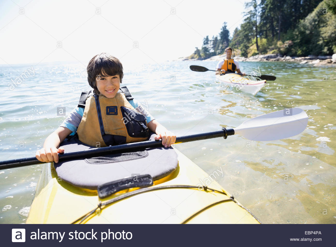 Portrait of father and son kayaking in ocean Stock Photo - Alamy