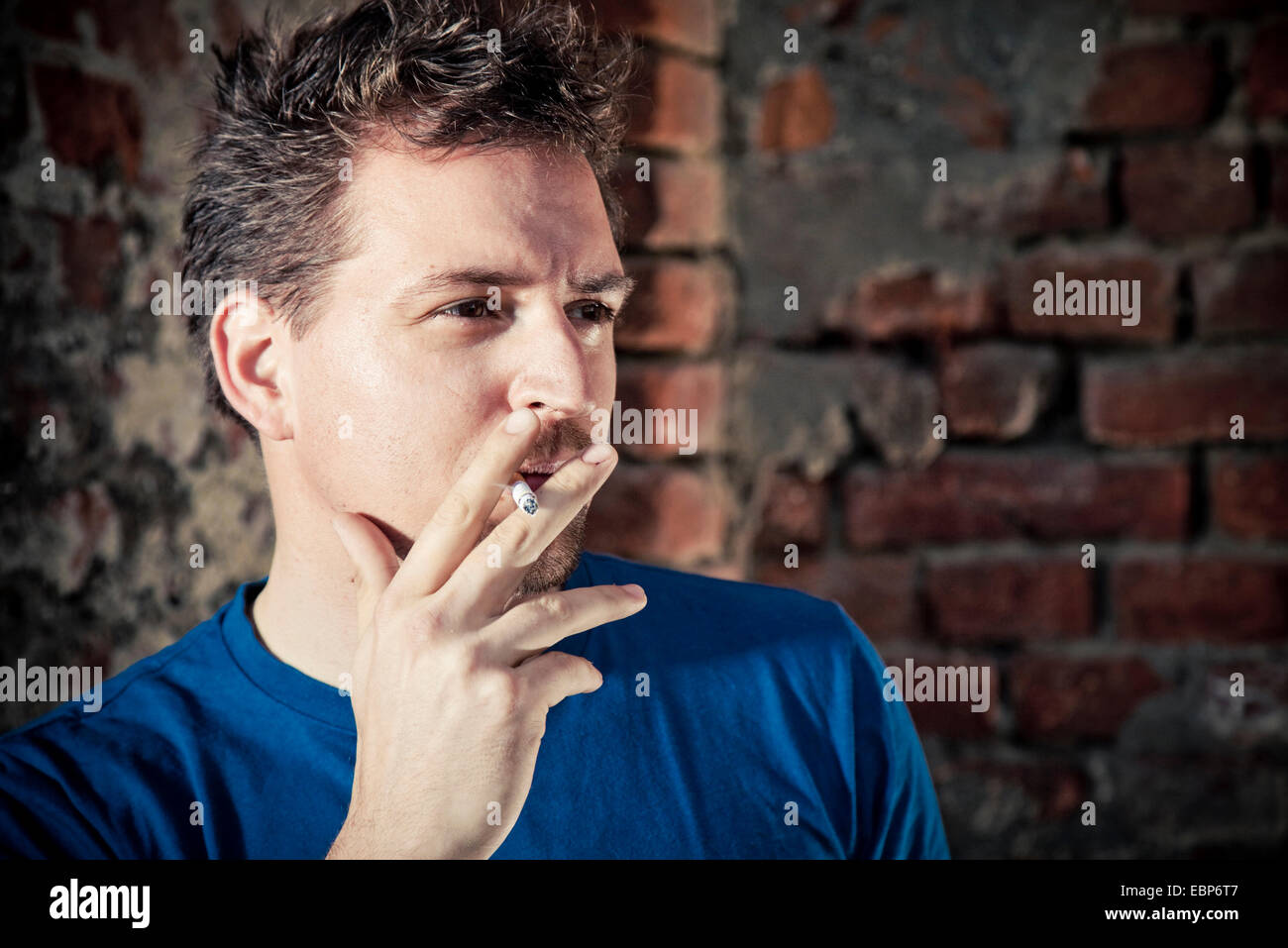 man smoking a cigarette Stock Photo - Alamy