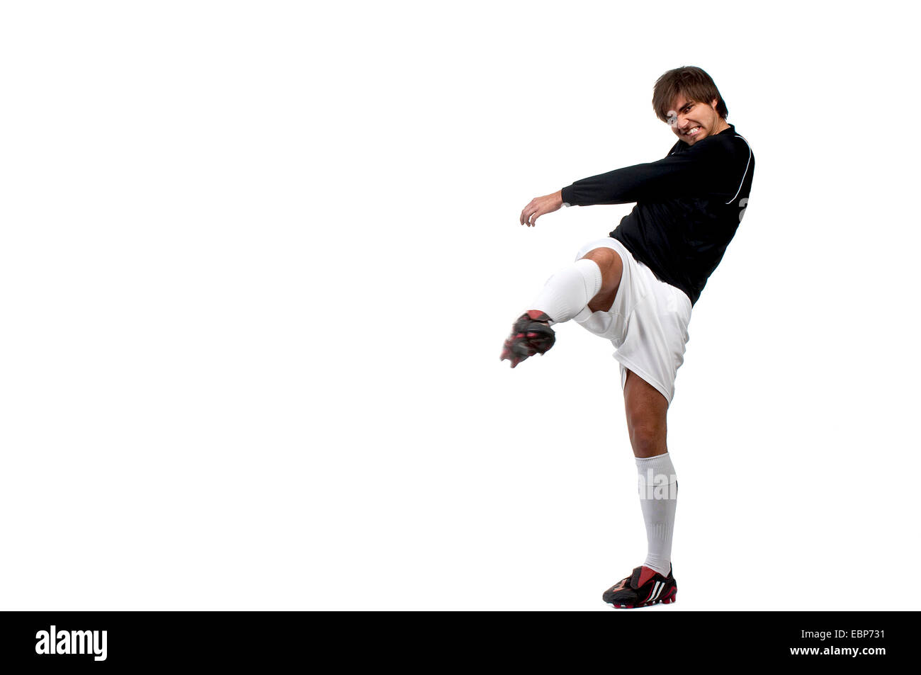 Football player kicking ball hi-res stock photography and images - Alamy