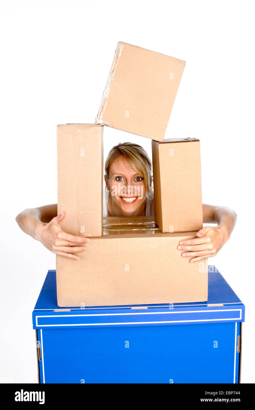young blond woman looking through boxes Stock Photo - Alamy
