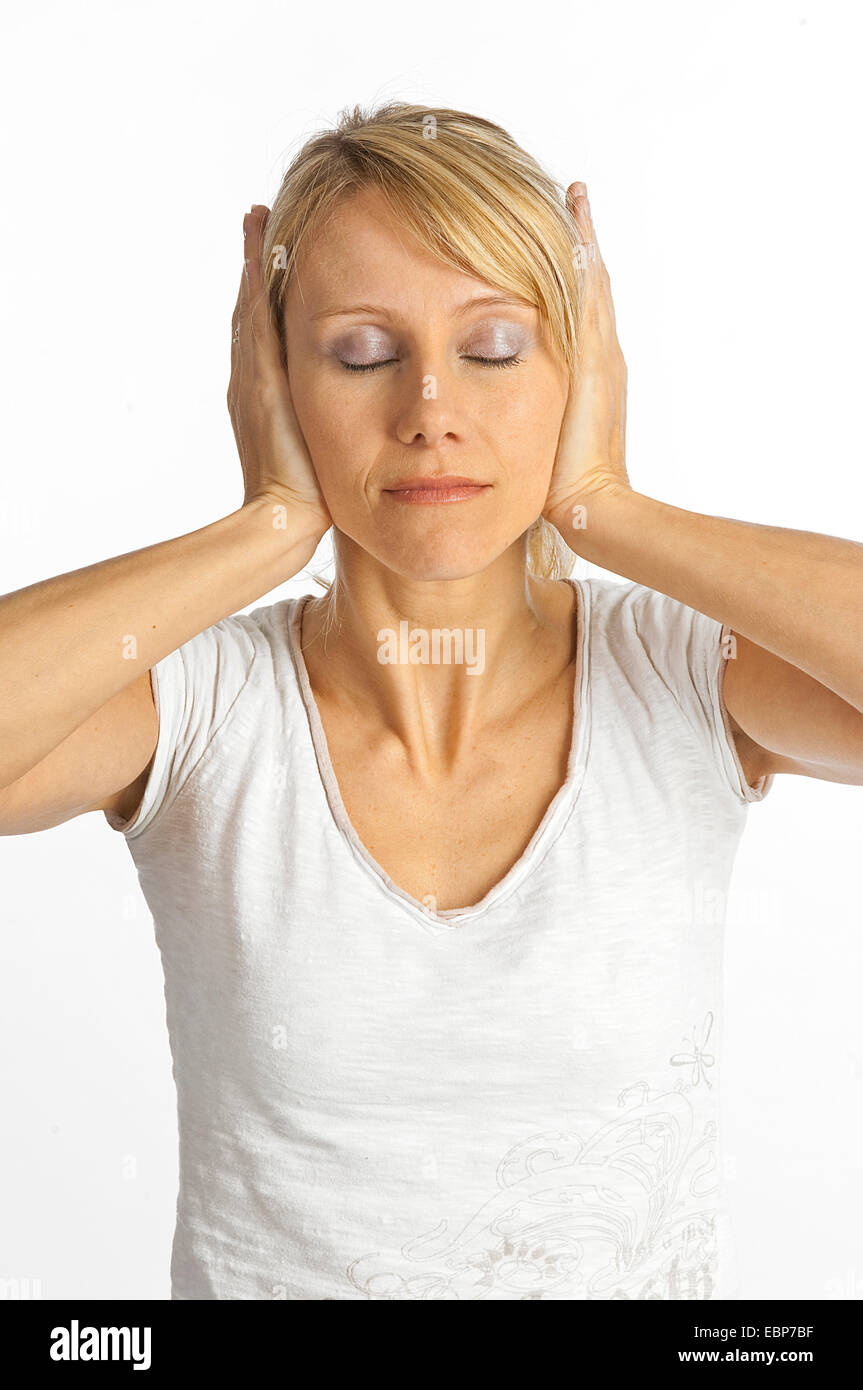 relaxed young woman with the eyes closed is keeping her ears shut Stock ...