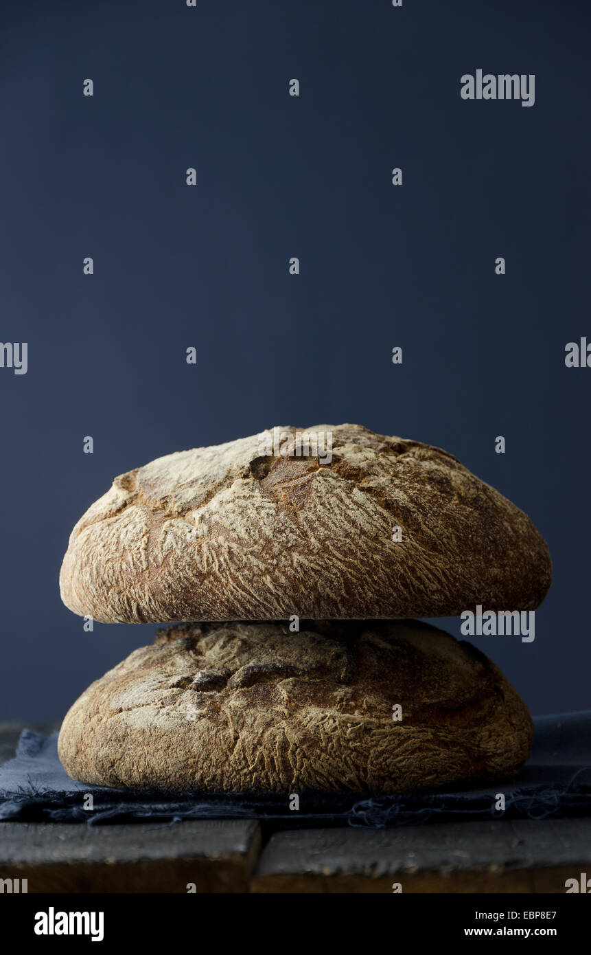 Traditional round bread over dark wooden table Stock Photo - Alamy