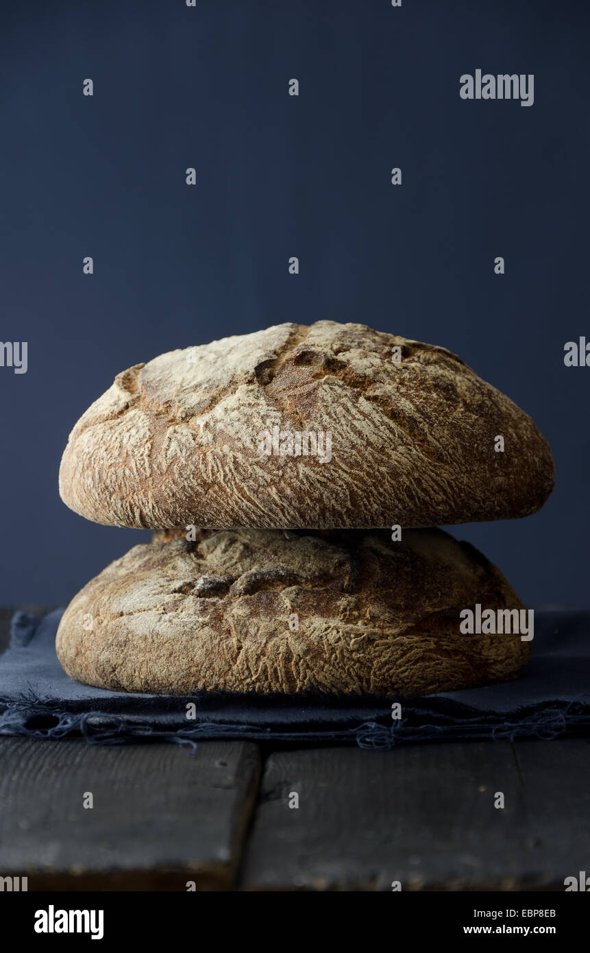 Traditional round bread over dark wooden table Stock Photo - Alamy