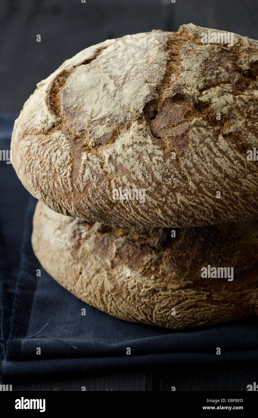 Traditional round bread over dark wooden table Stock Photo - Alamy