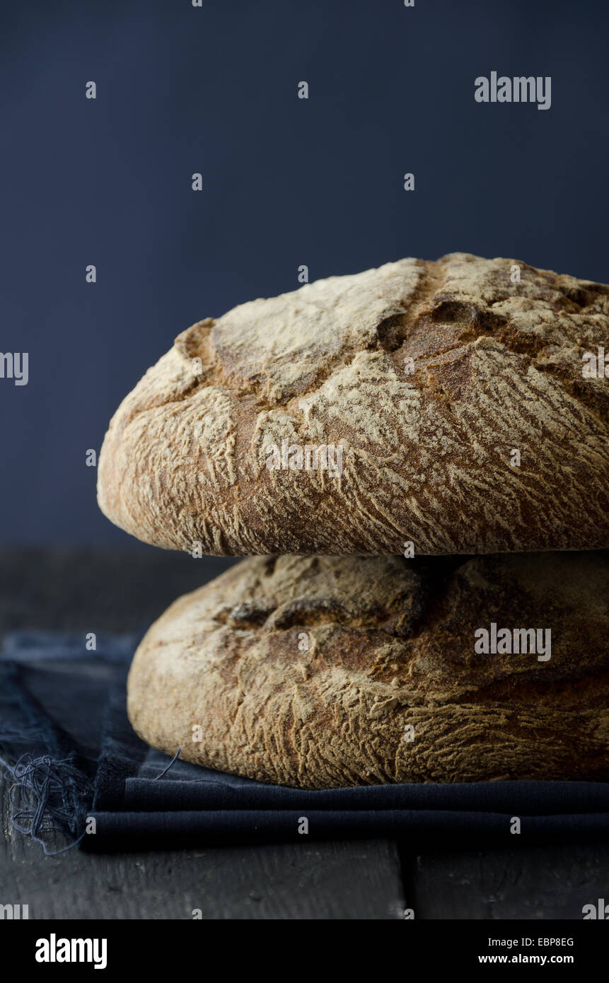Traditional round bread over dark wooden table Stock Photo - Alamy