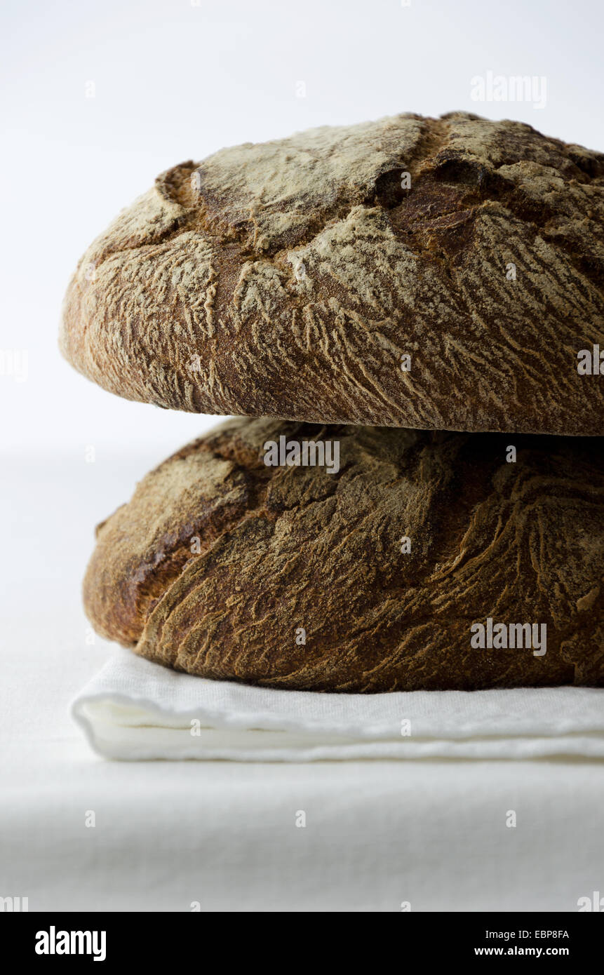 Traditional round bread over white cloth table Stock Photo - Alamy