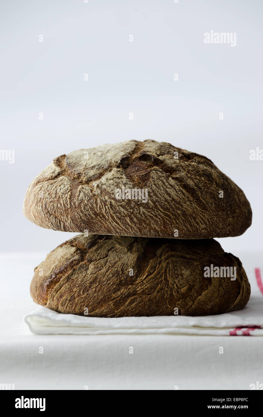 Traditional round bread over white cloth table Stock Photo - Alamy