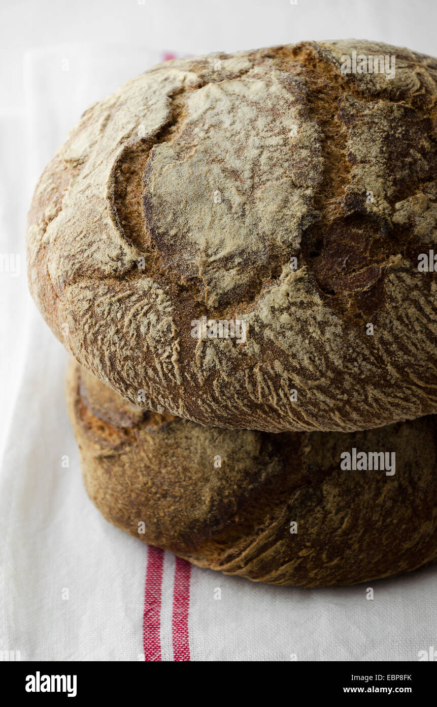 Traditional round bread over white cloth table Stock Photo - Alamy