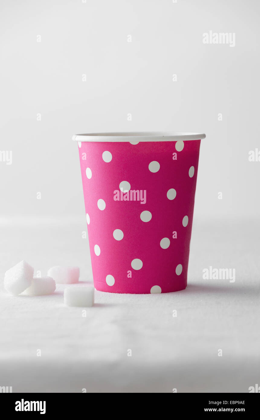 Coffee in a pink paper cup with dots pattern over white cloth Stock ...
