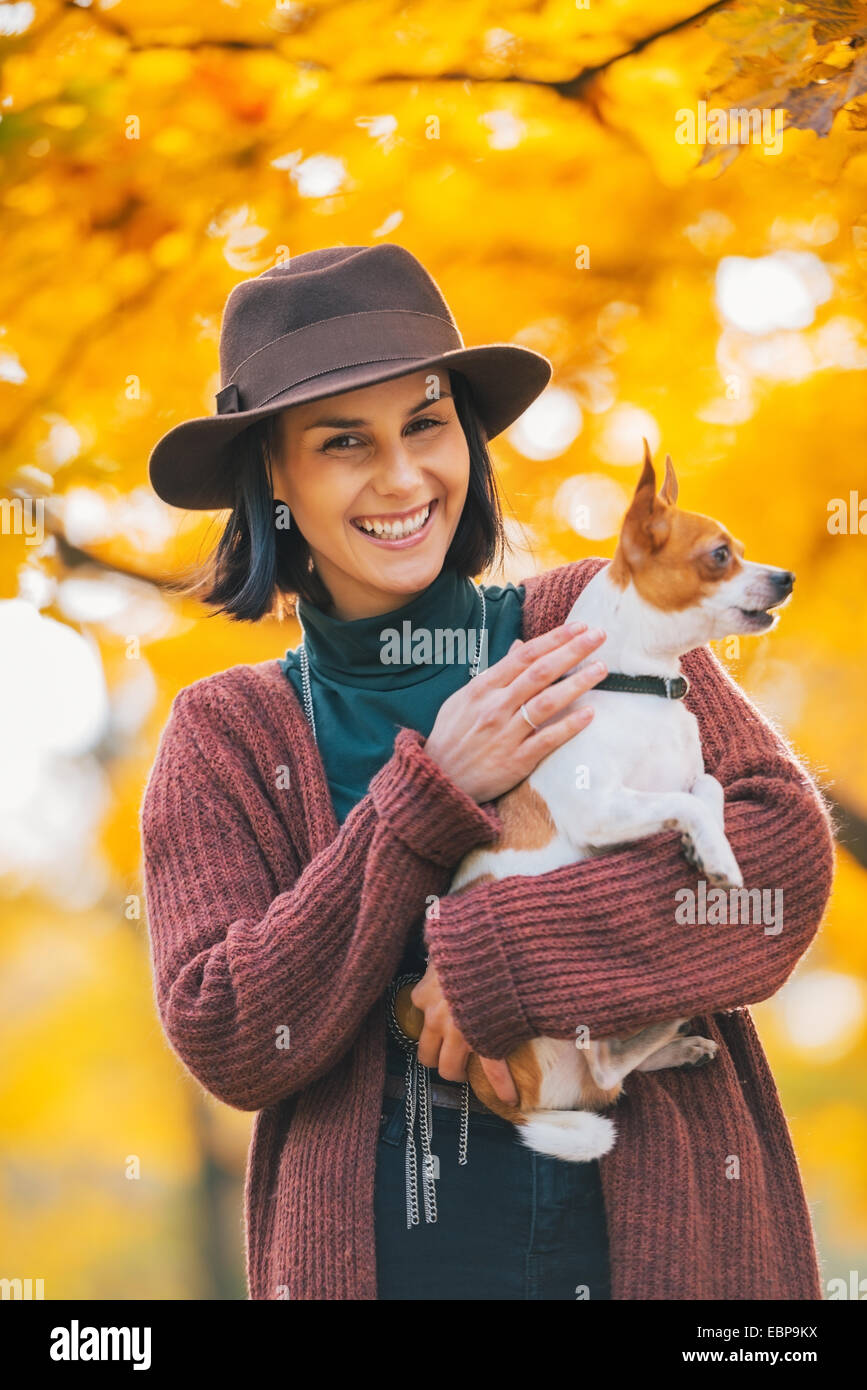 Portrait of happy young woman dog outdoors in autumn Stock Photo - Alamy