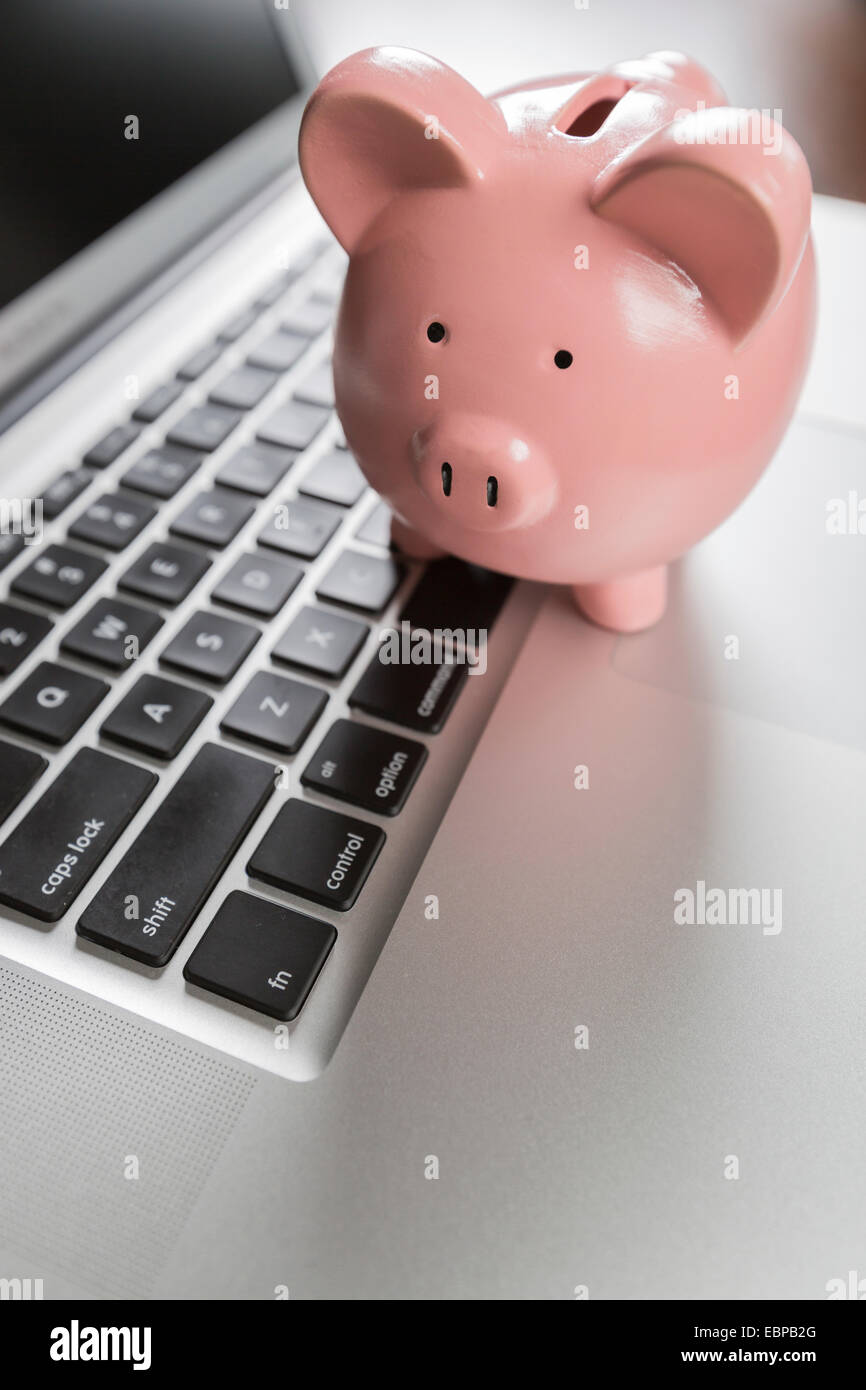 Piggy Bank Resting on Laptop Computer Keyboard Stock Photo - Alamy