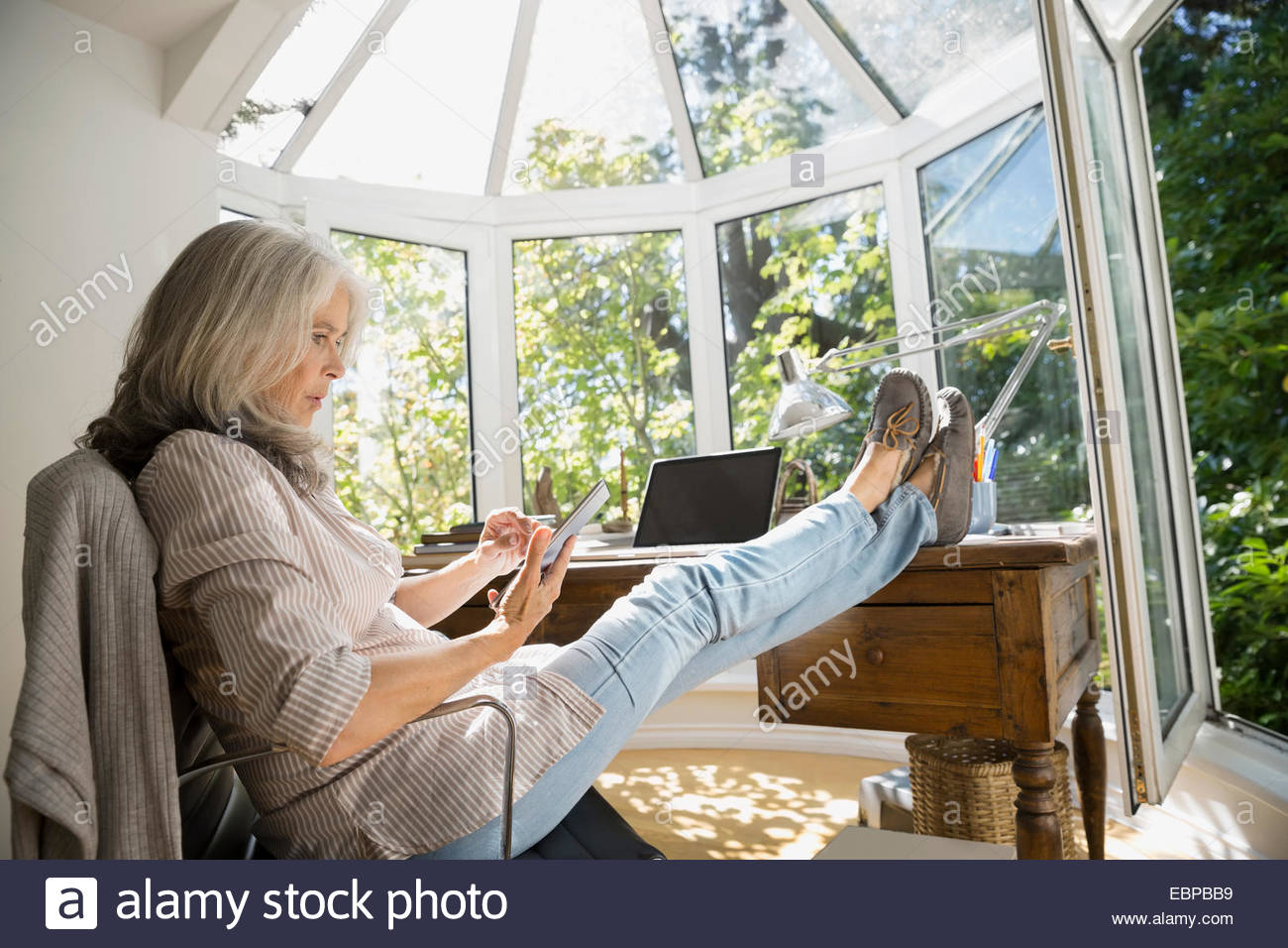 Woman with feet up hi-res stock photography and images - Alamy