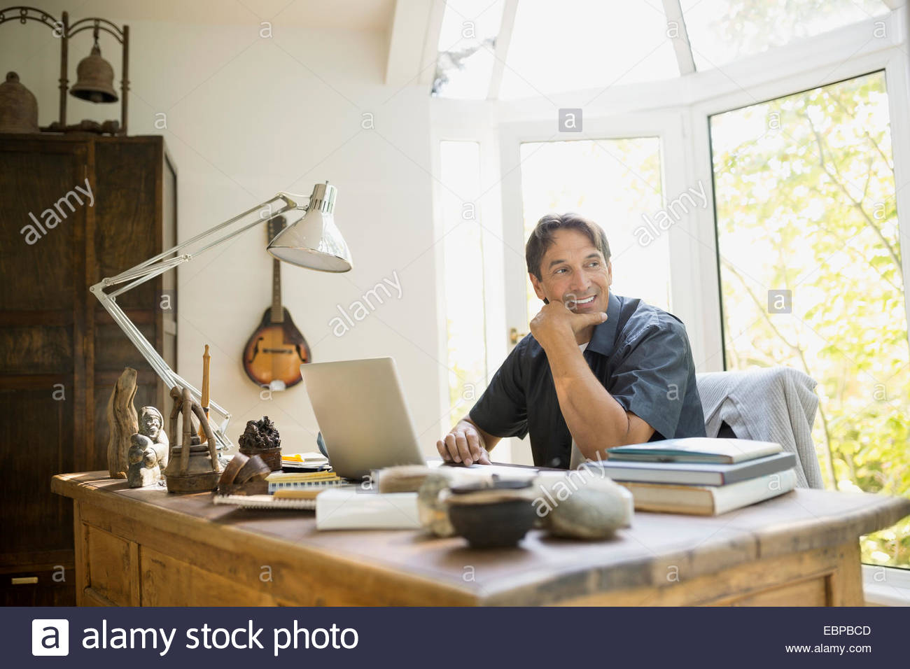 Man working at laptop in home office Stock Photo - Alamy