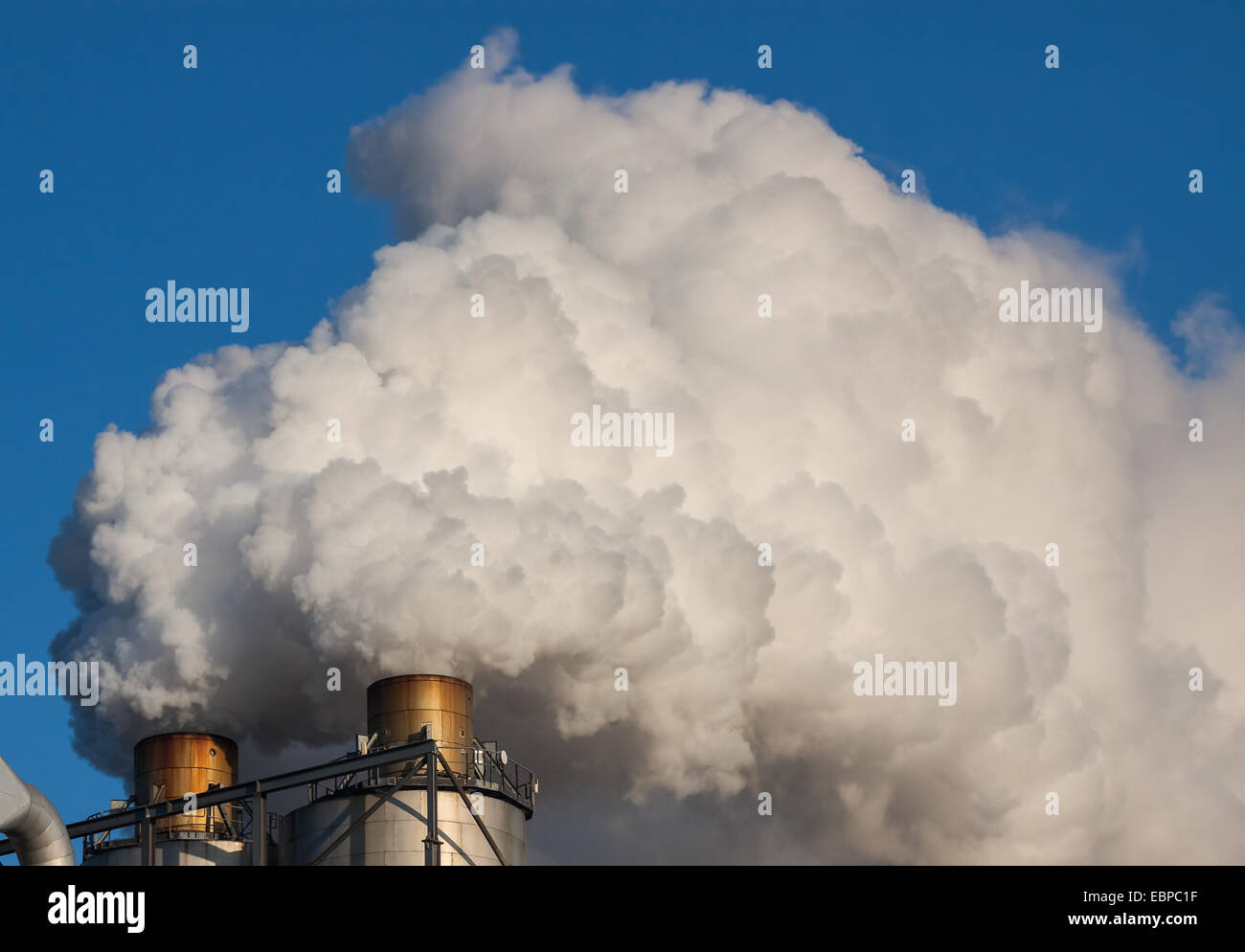 Smoke clouds from a chimney against blue sky Stock Photo - Alamy