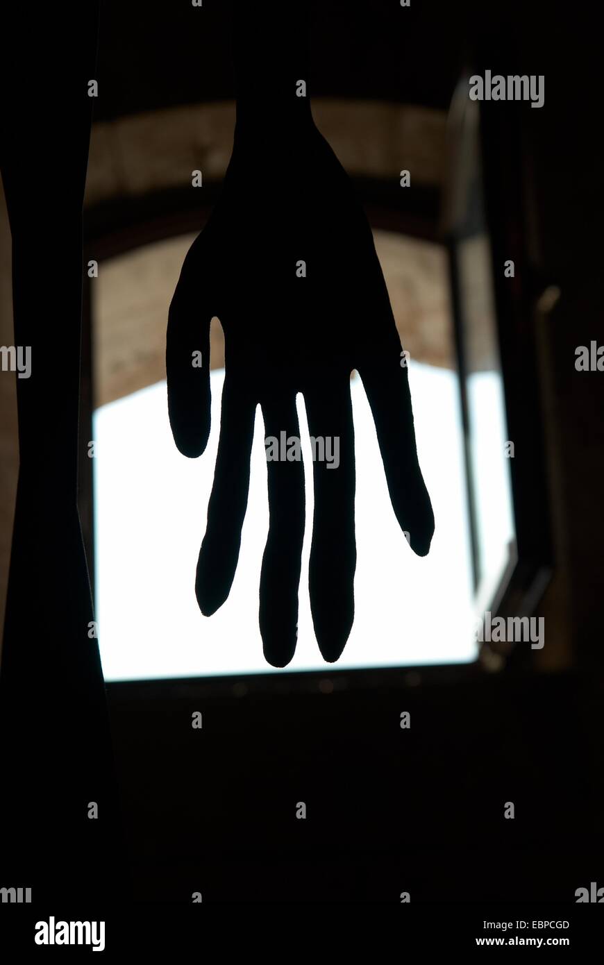 Black hand in front of the window Stock Photo - Alamy