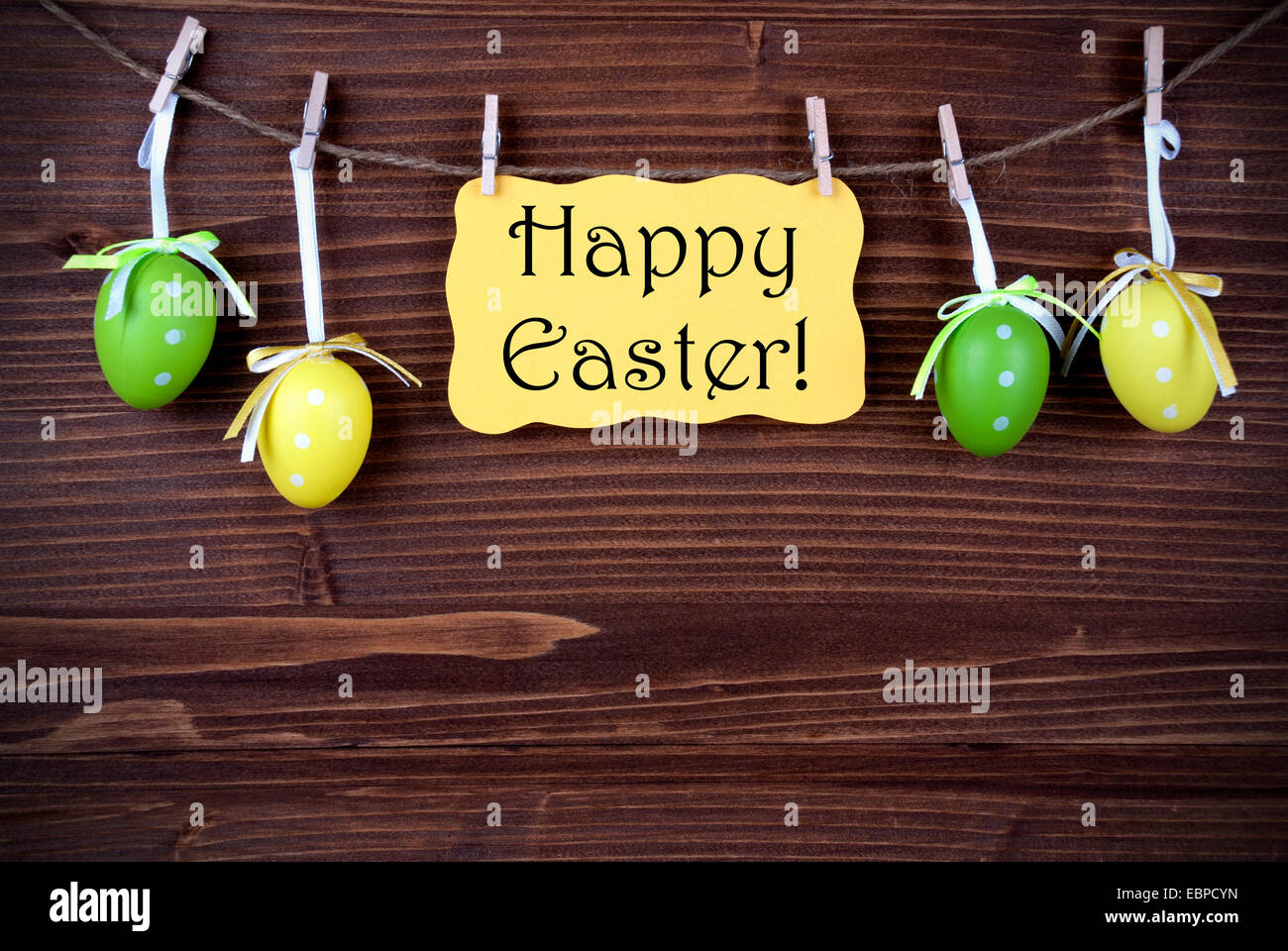 Yellow Easter Label With Happy Easter Hanging On A Line With Two Green ...