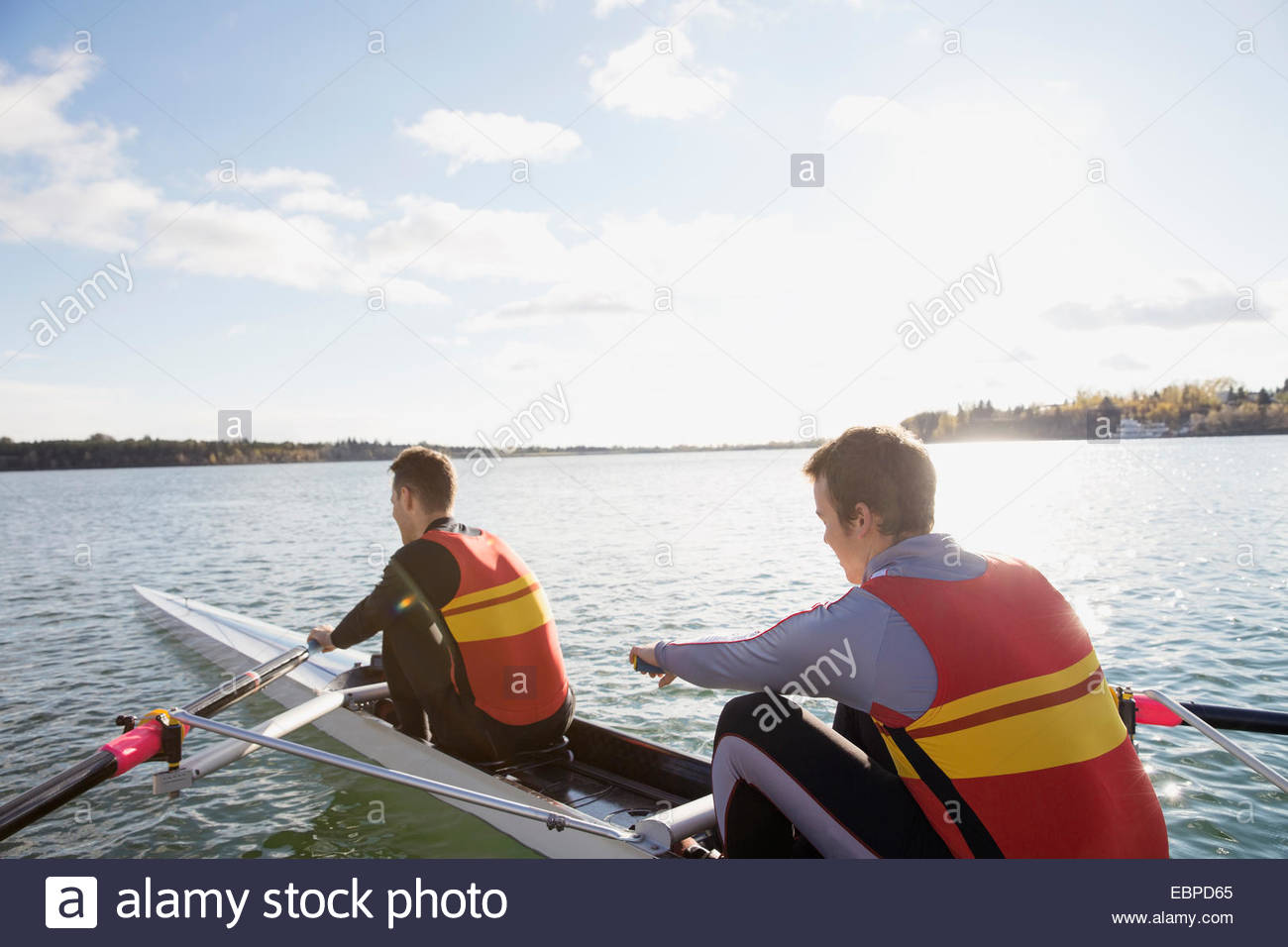 Rowing team in scull on river Stock Photo - Alamy