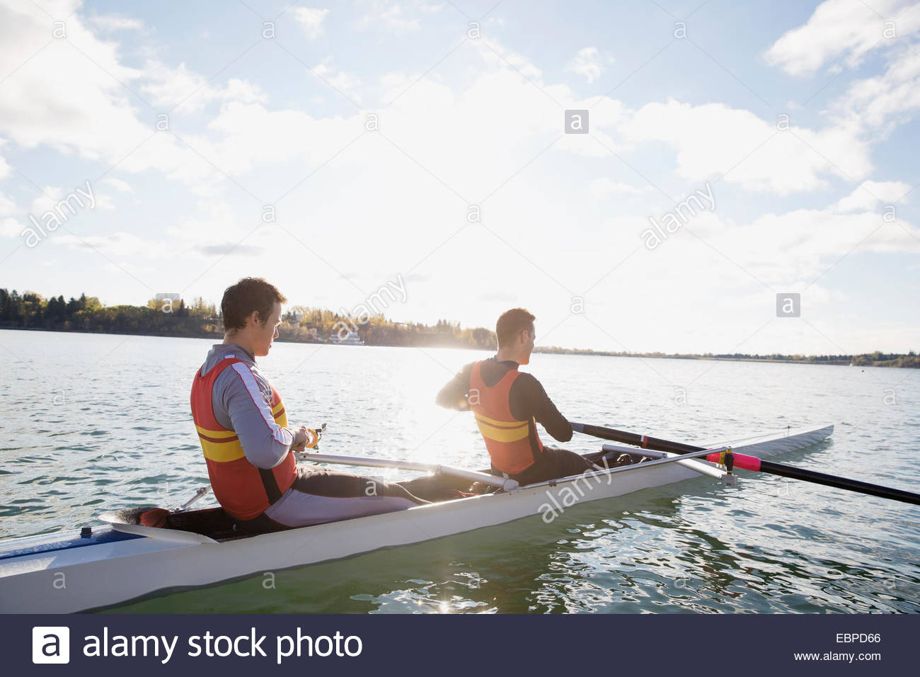 Three people rowing boat hi-res stock photography and images - Alamy