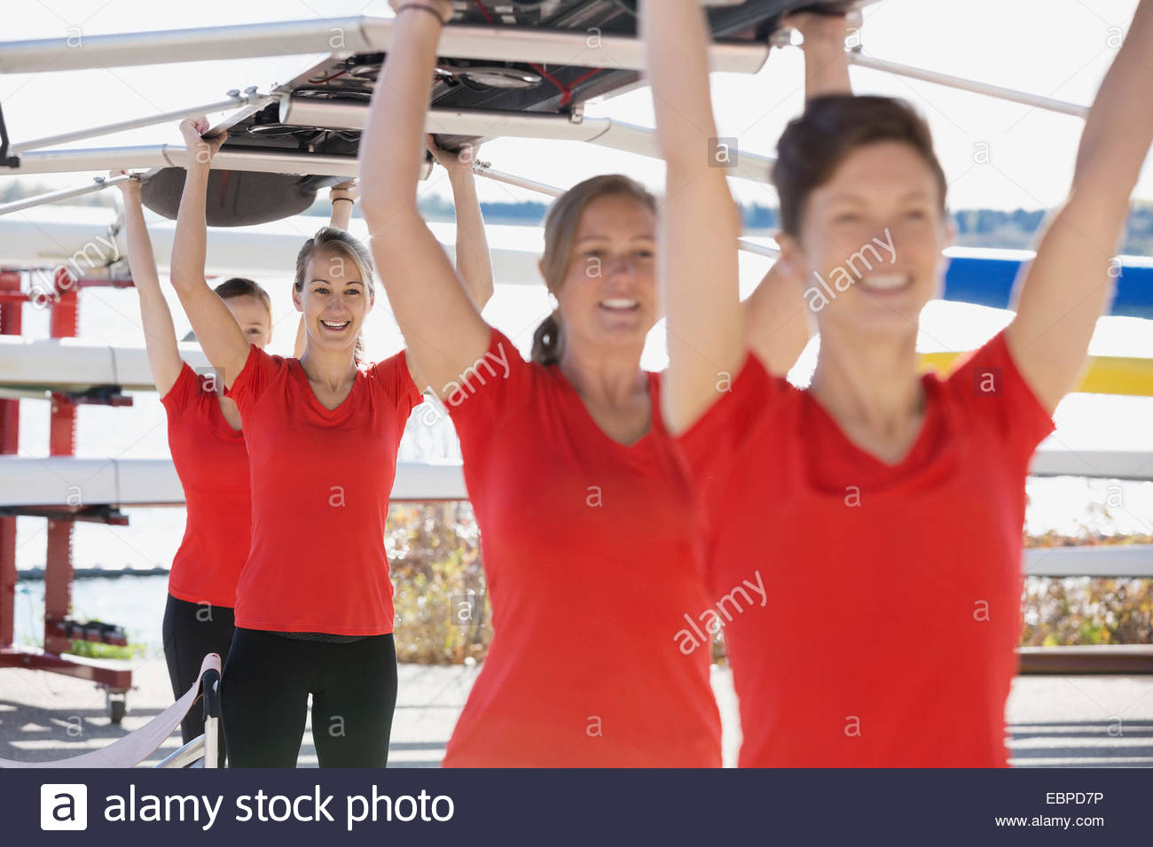 Rowing team carrying scull overhead Stock Photo - Alamy
