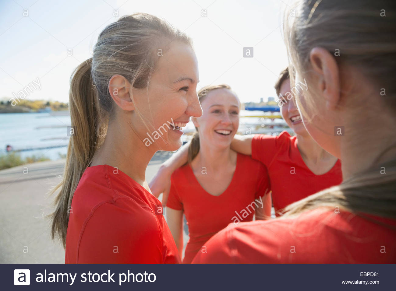 Rowing team talking in huddle Stock Photo - Alamy