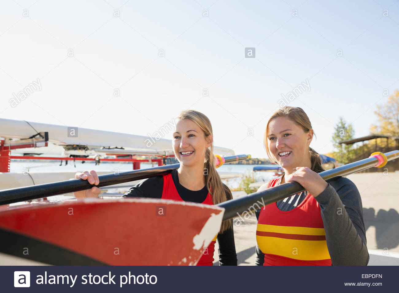 Smiling rowers carrying oars Stock Photo - Alamy