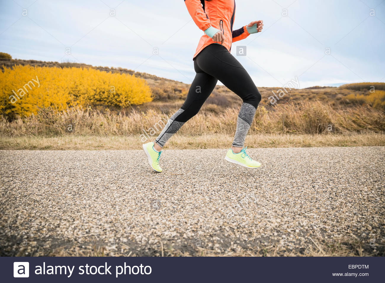 Woman running road day hi-res stock photography and images - Alamy