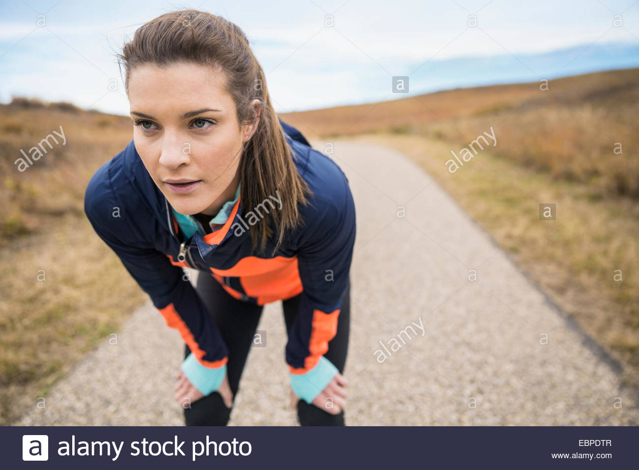 Runner resting on rural path Stock Photo - Alamy