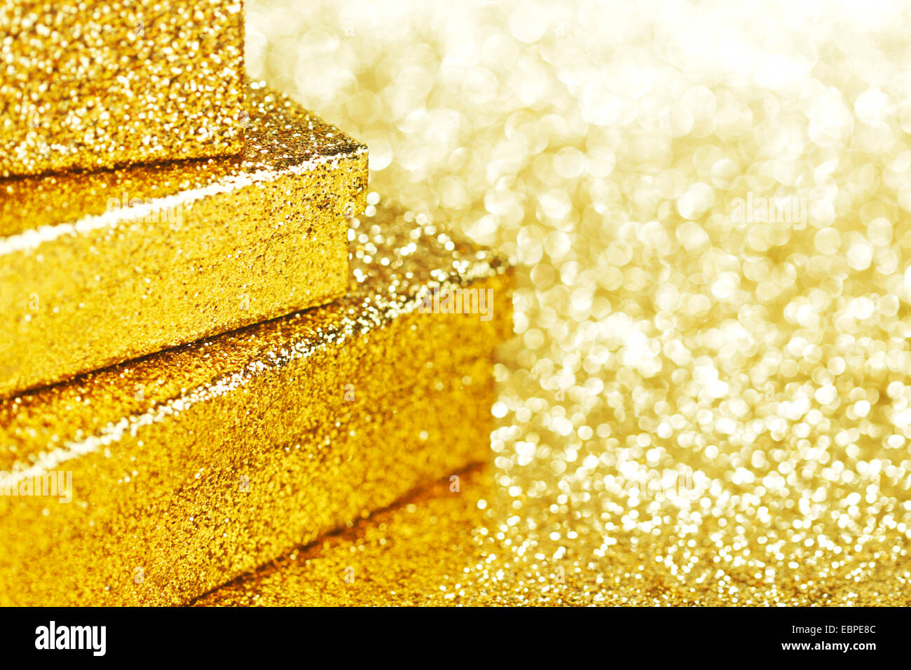 Decorative golden boxes with holiday gifts on shiny glitter background ...