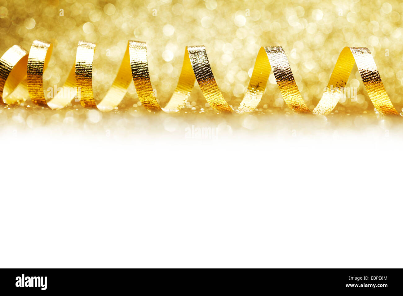 Golden curly ribbon decoration on glitter background close-up Stock ...