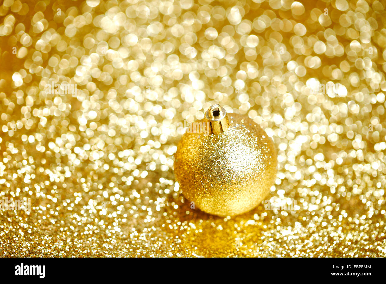 Golden christmas ball on shining glitter background close-up Stock ...