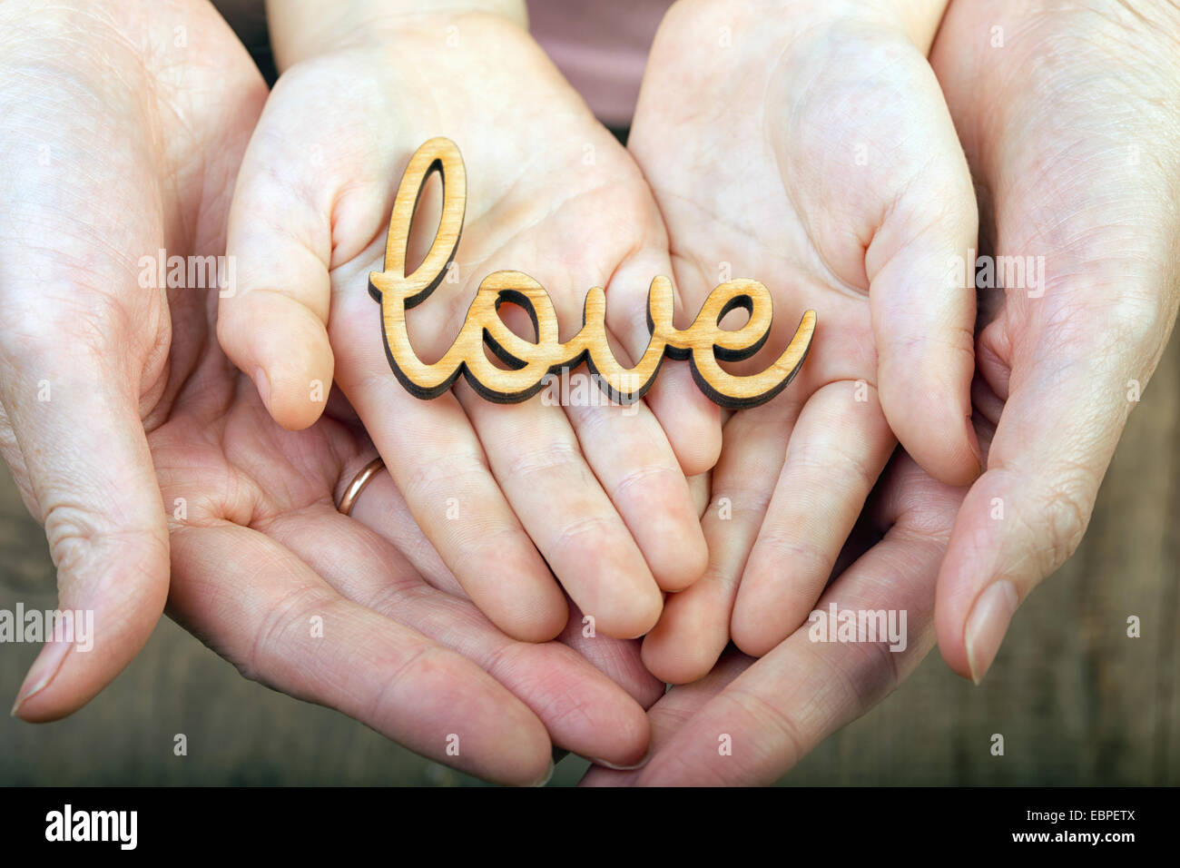 hands holding word love Stock Photo - Alamy