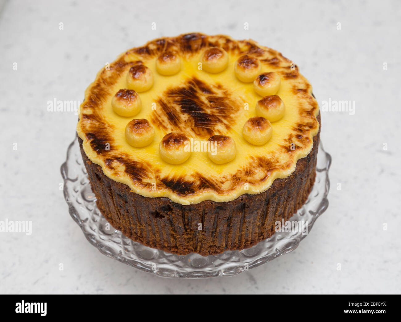 Traditional uncut home baked Easter simnel cake, topped with toasted ...
