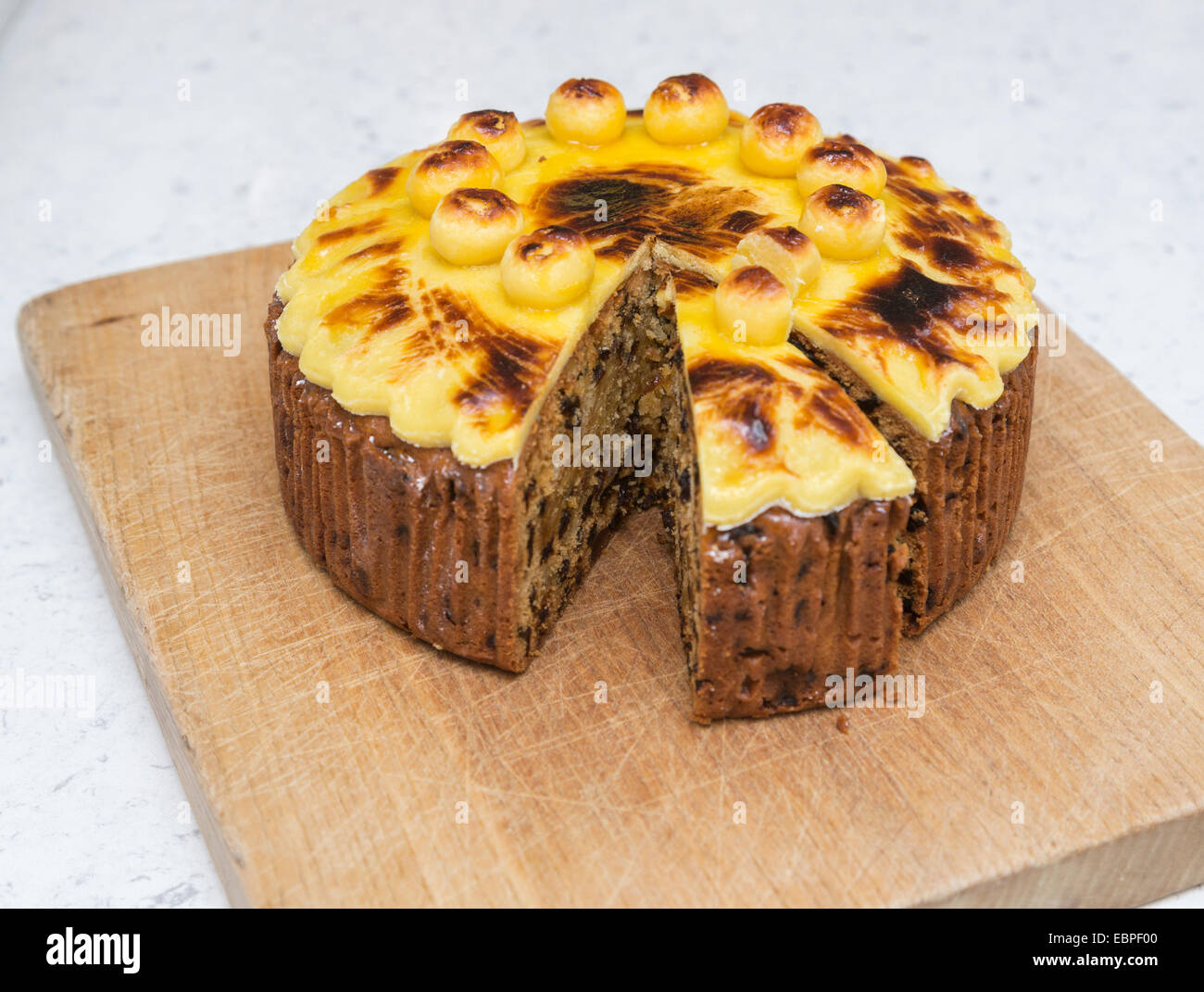 Traditional home baked Easter simnel cake with a cut slice removed ...