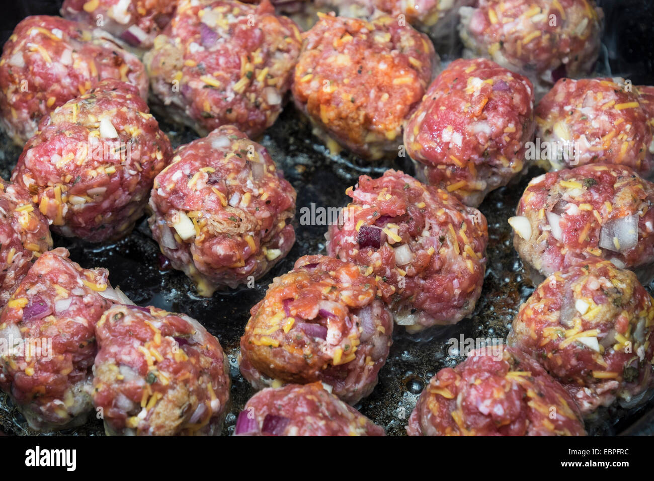 Italian style meatballs cooking on a pan Stock Photo - Alamy