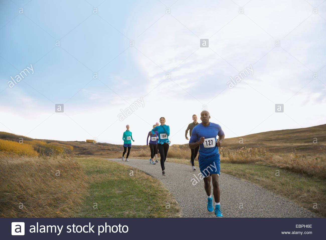 Runners racing on rural path Stock Photo - Alamy