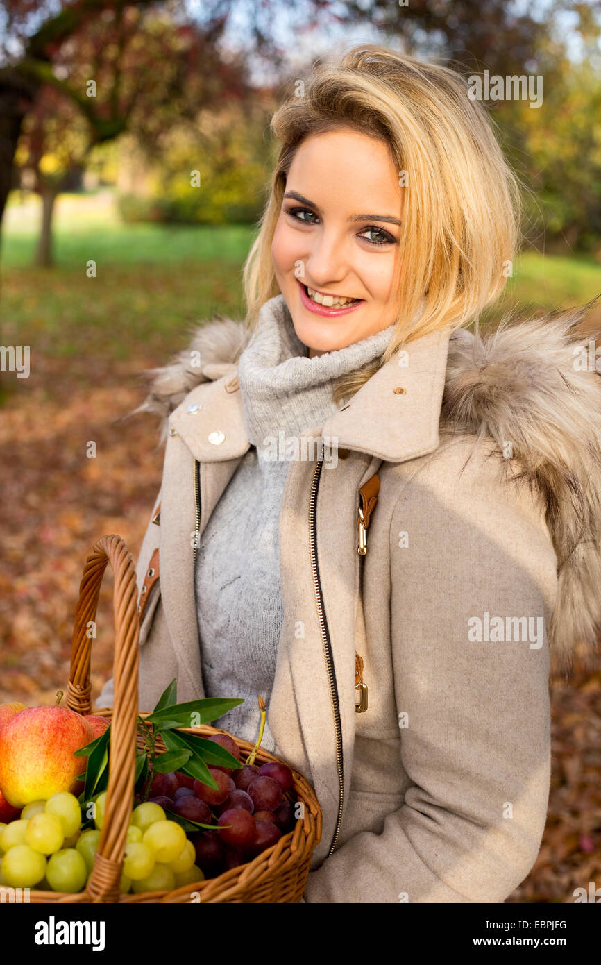 Woman holding fruit basket hi-res stock photography and images - Alamy