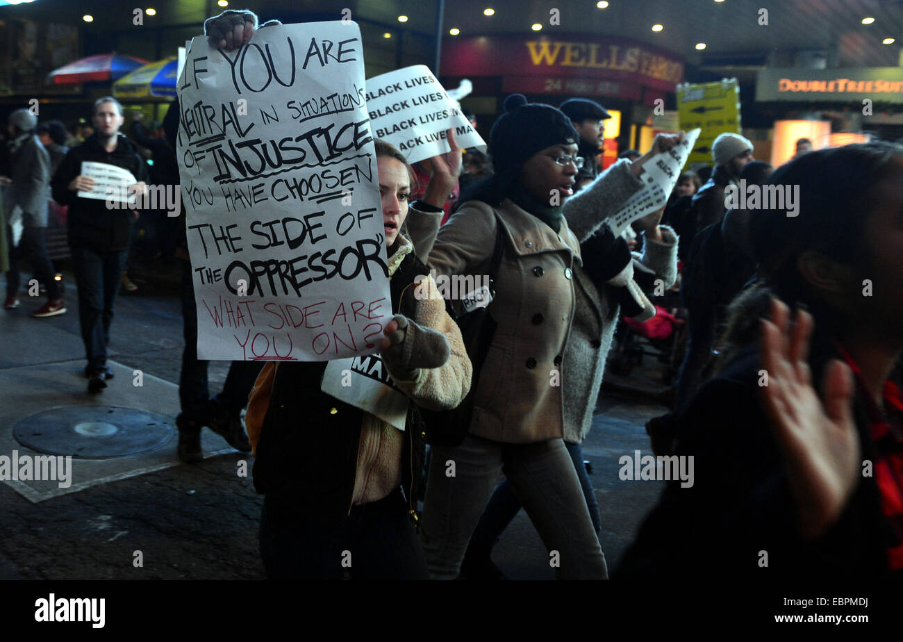New York, USA. 3rd Dec, 2014. Protesters holding banners march at ...