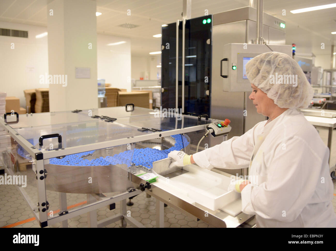 An employee at the Takeda pharmaceutical company works with medication ...