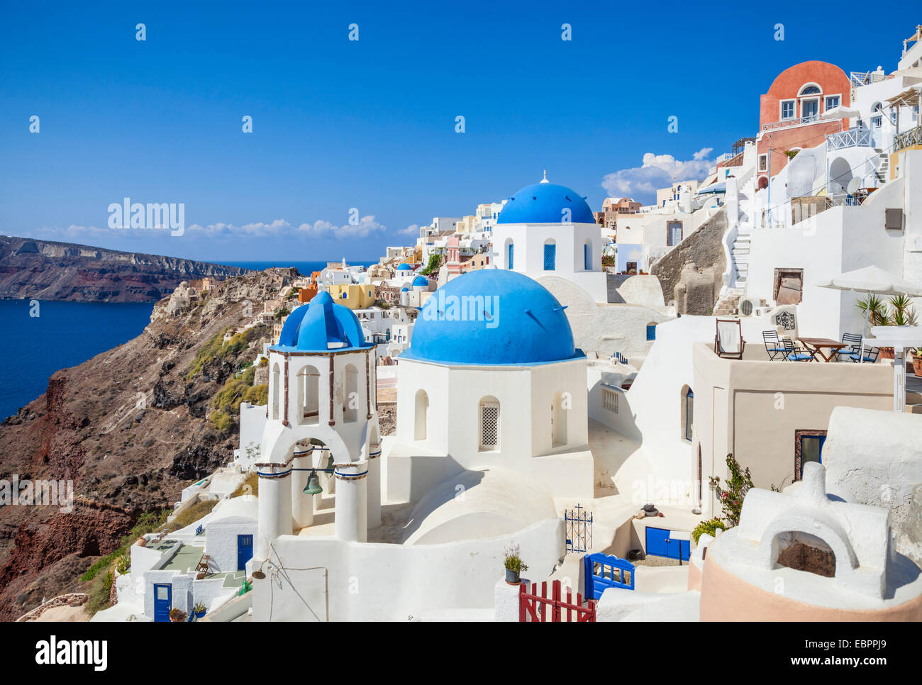 Greek church with three blue domes in the village of Oia, Santorini ...