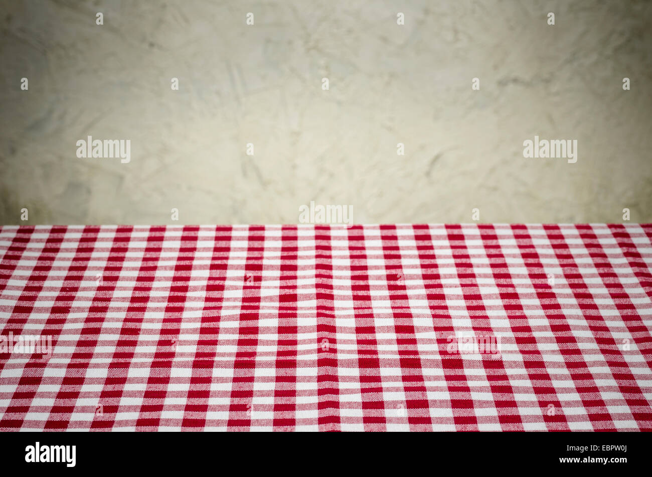 Background with checkered tablecloth and a rustic wall Stock Photo - Alamy