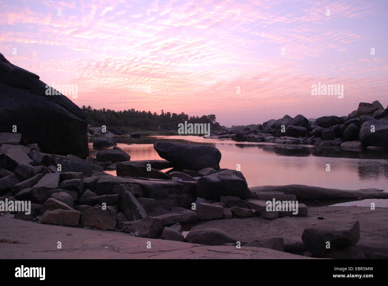 Sunset and amazing rocks on the river, Hampi Stock Photo - Alamy