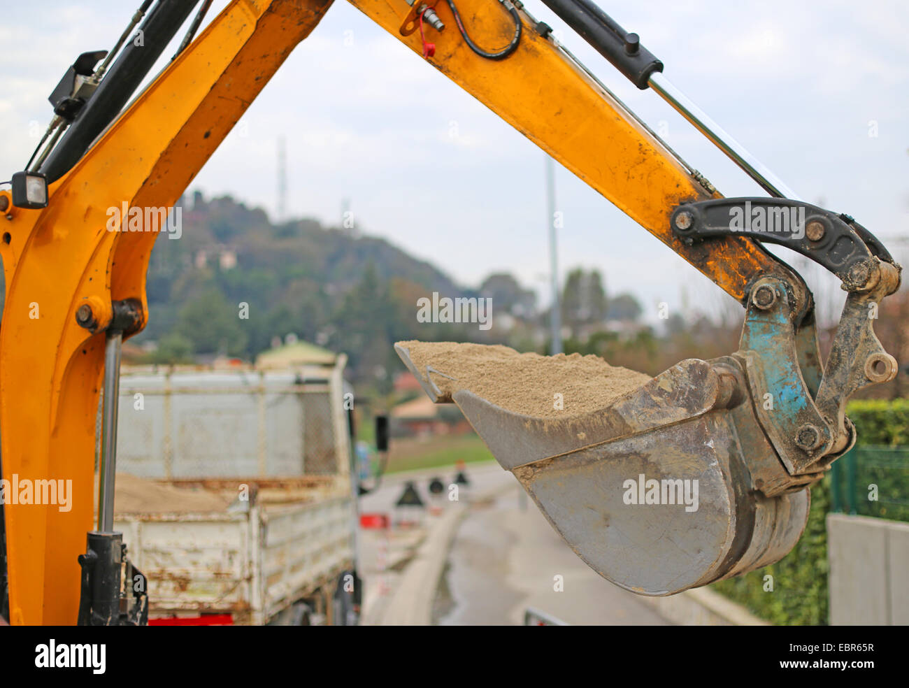 huge bucket of a bulldozer and a truck in the background during the ...