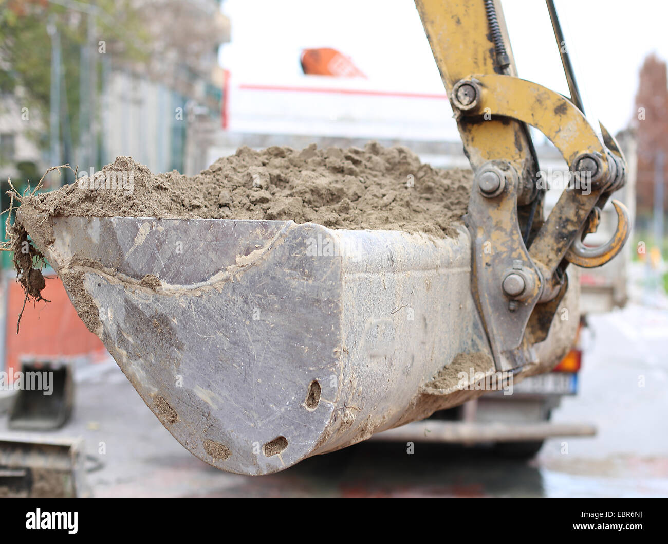 big bucket of a bulldozer and a truck in the background Stock Photo - Alamy