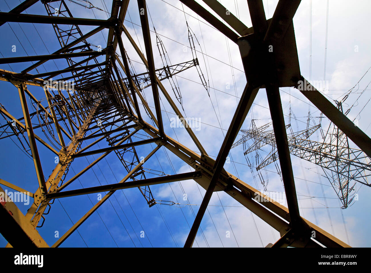power pole from below with high voltage power lines, Germany, North ...