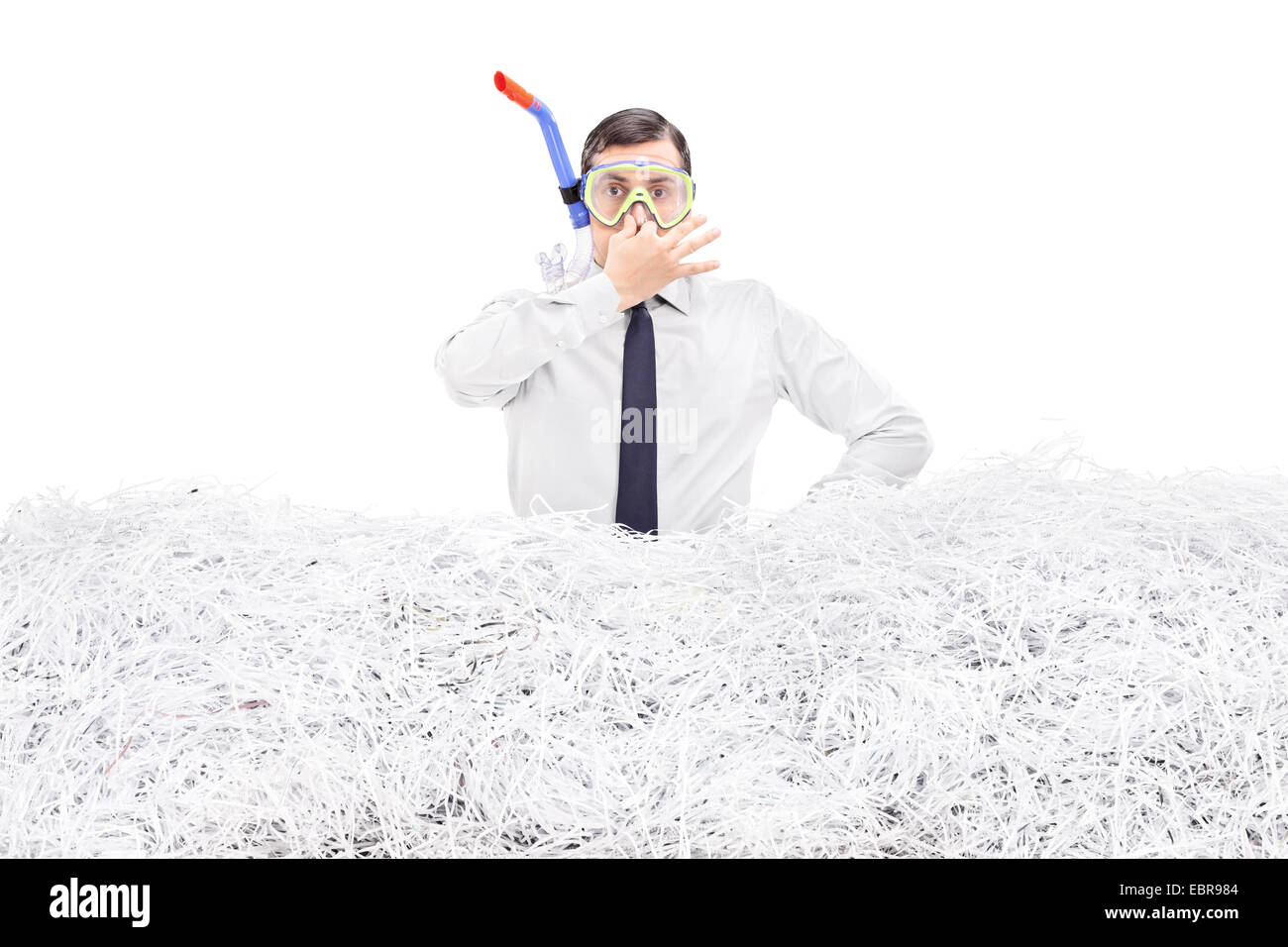 Businessman diving into a pile of shredded paper isolated on white ...