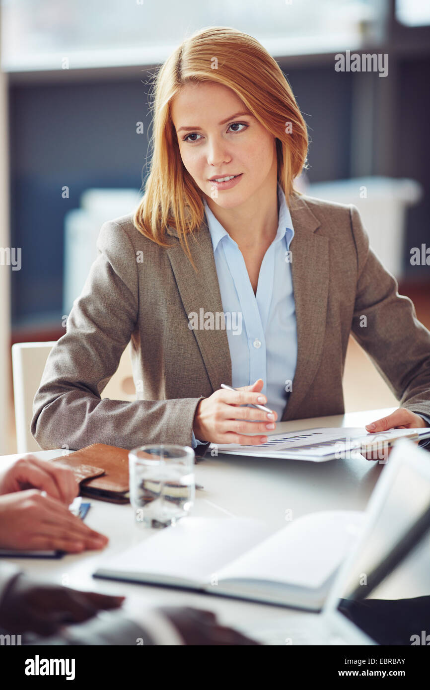 Elegant secretary with document sitting at business meeting Stock Photo ...