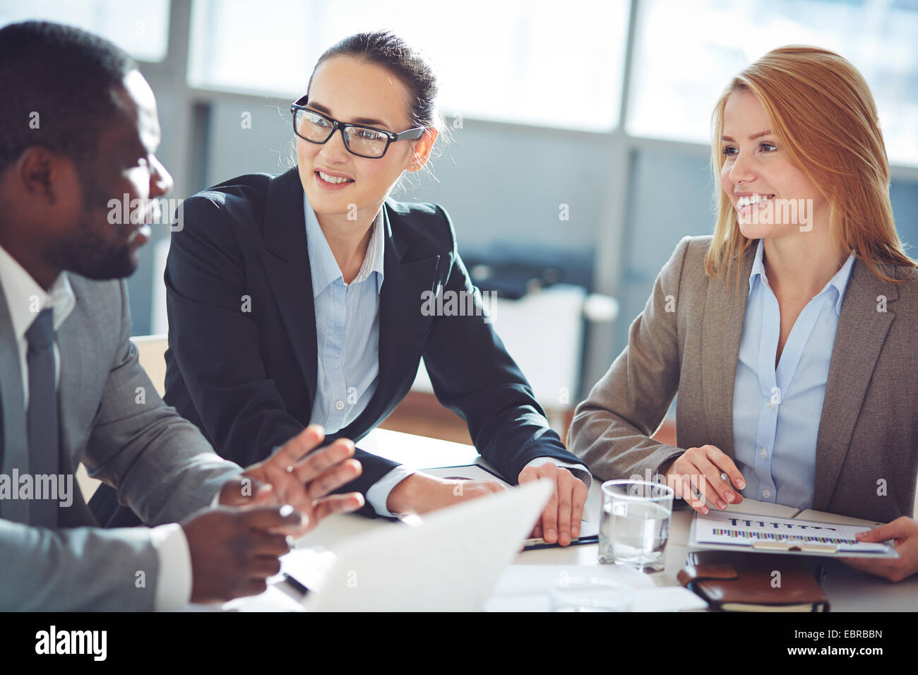 Two businesswomen interviewing young man Stock Photo - Alamy