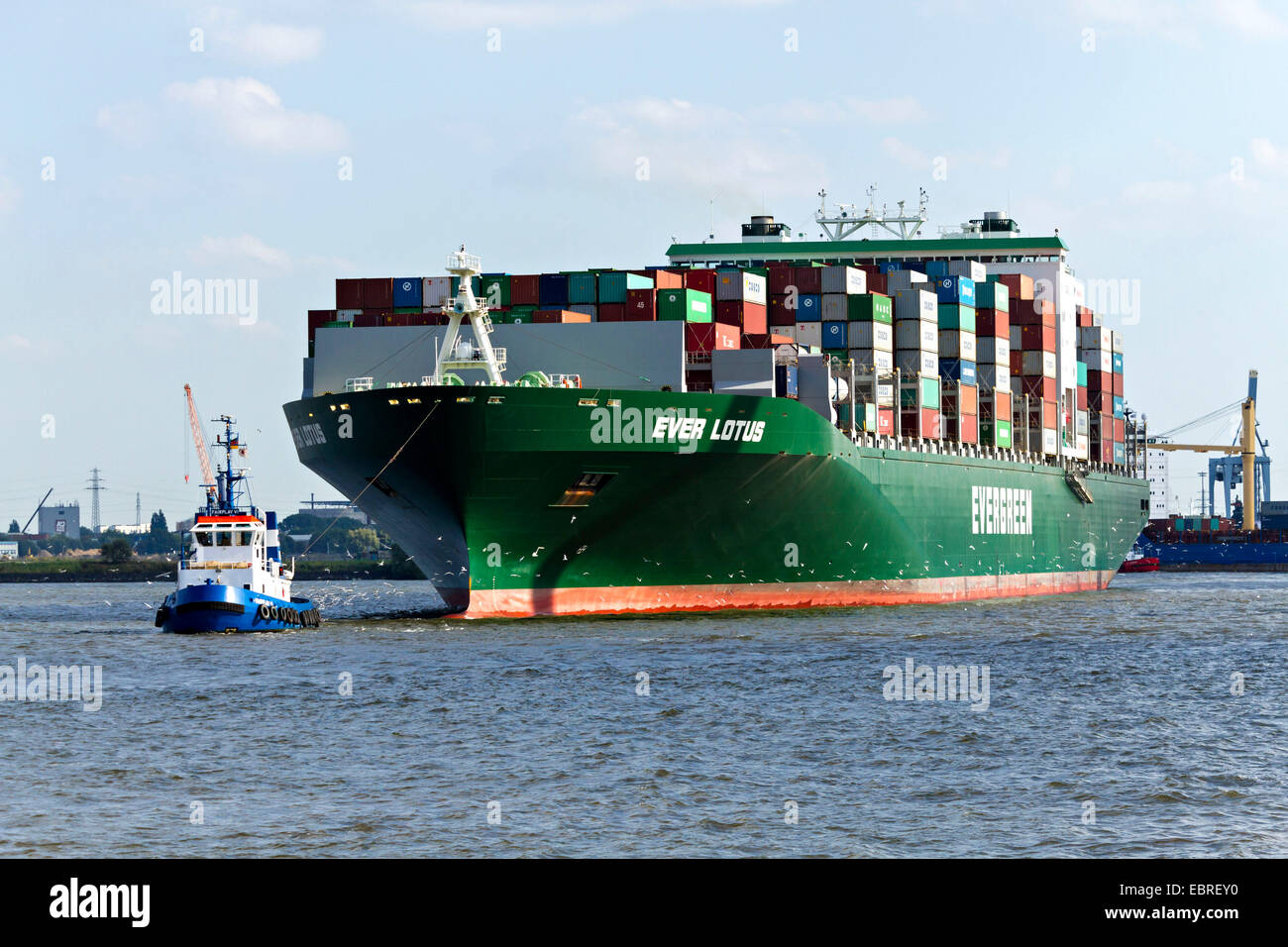 Container Ship Ever Lotus being towed by tug boat, Hamburg Harbour ...