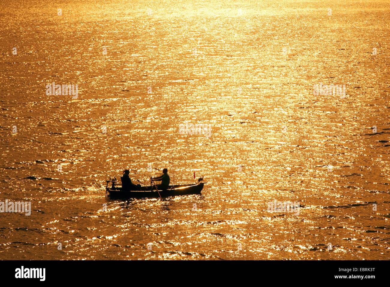 Rowing boat at sunset hi-res stock photography and images - Alamy