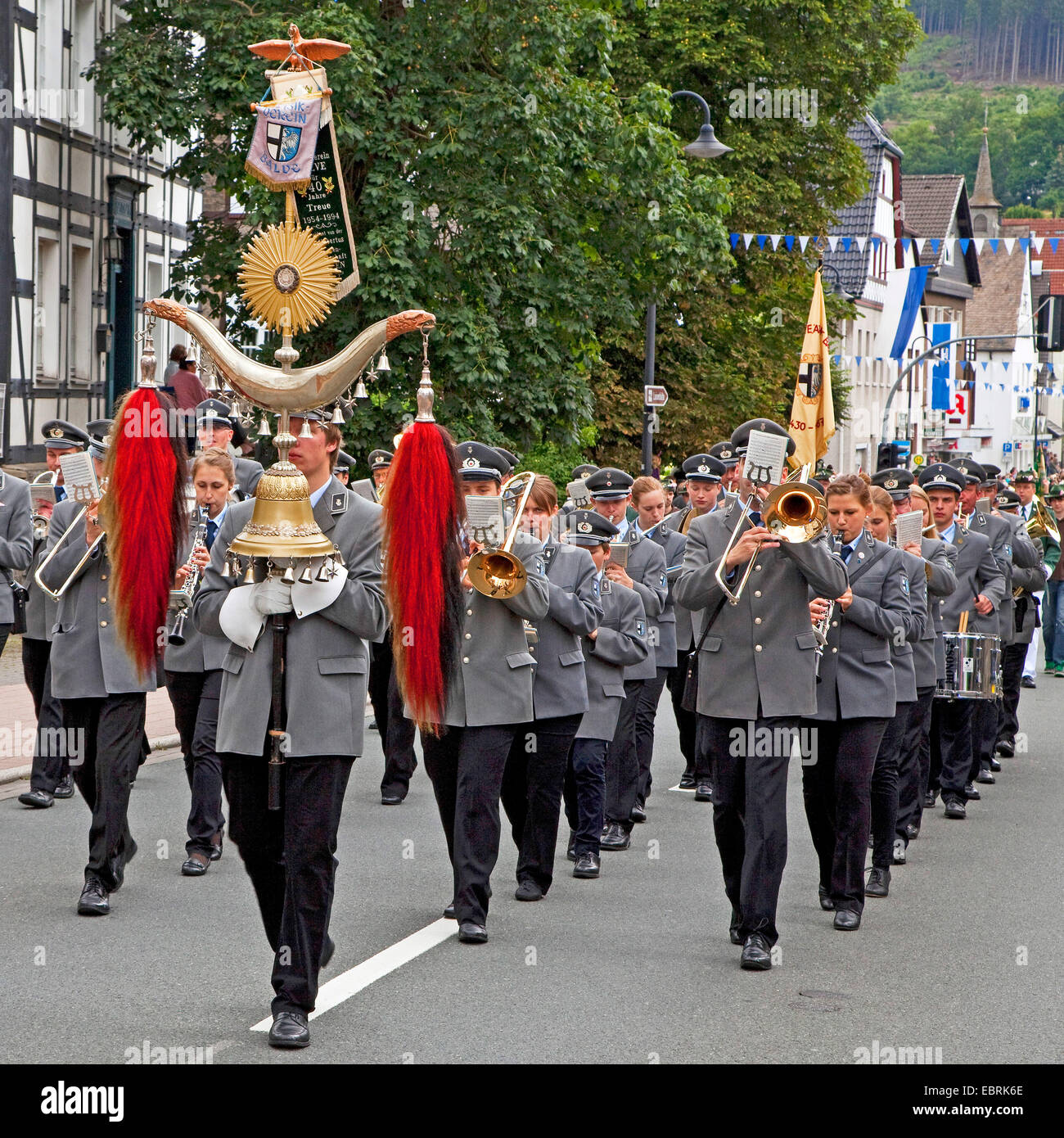 procession through the streets at a fair featuring shooting matches in ...